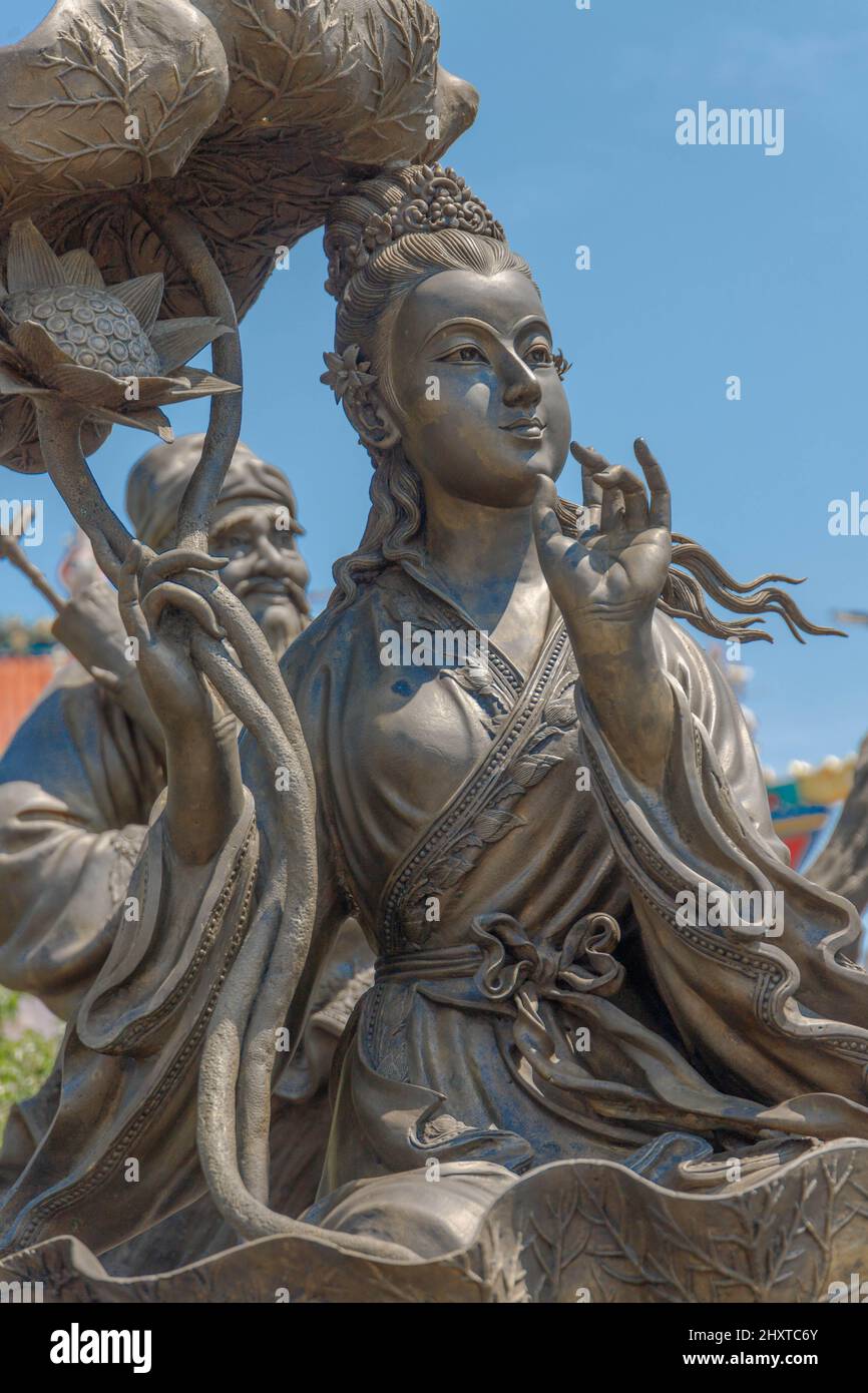 Vertical photo of bronze statues of Japanese characters outdoors ...