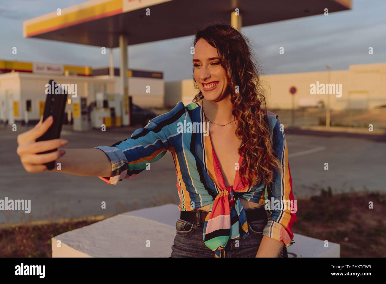Closeup Of An Attractive Woman Taking A Selfie At A Gas Station Stock