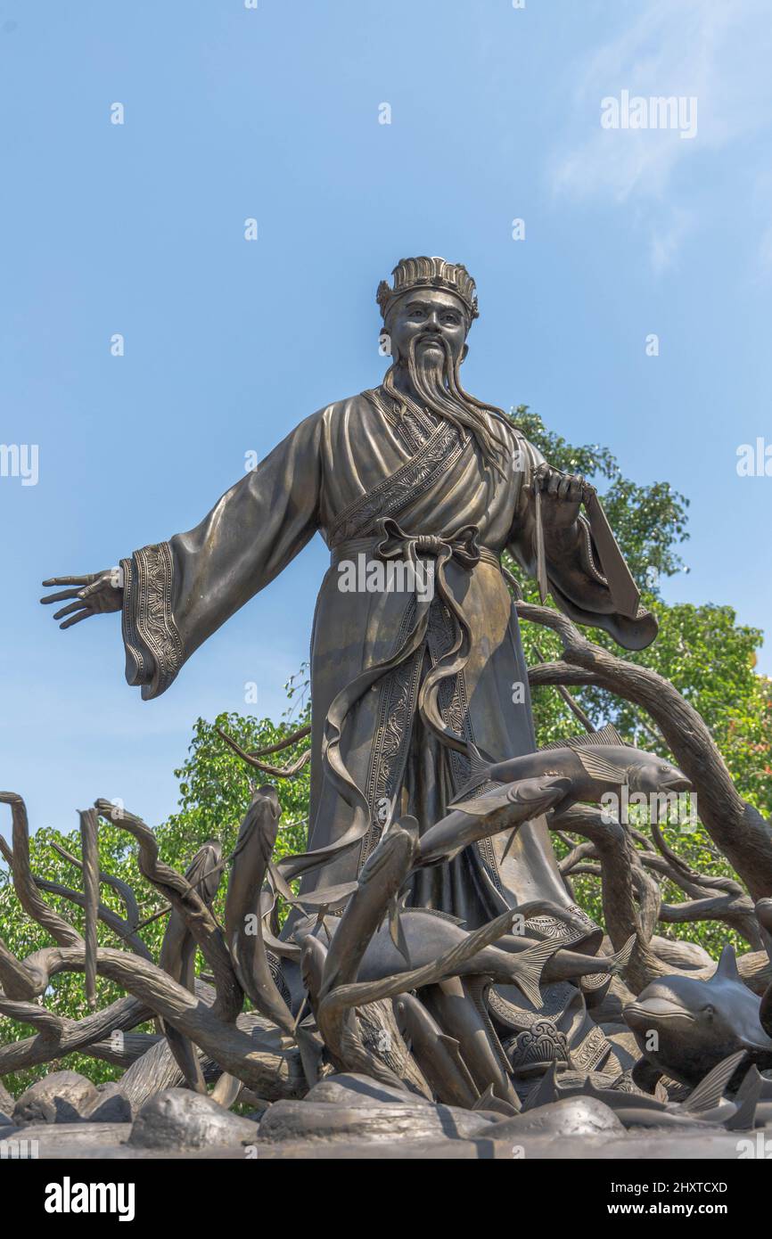 Vertical photo of bronze statues of a Japanese character representing ...