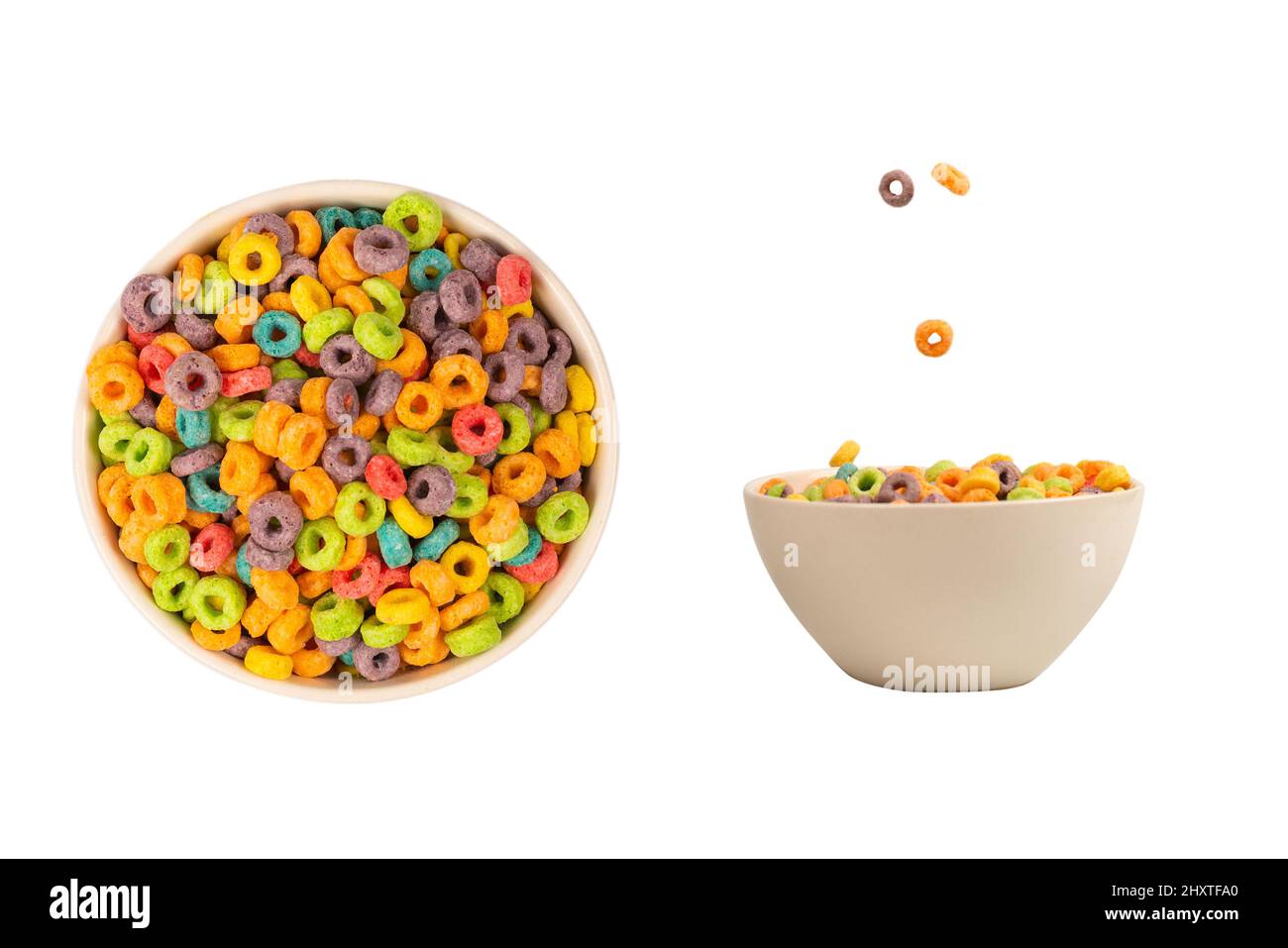 Colorful rings cereal spill out into a bowl. Breakfast. Isolated on a ...
