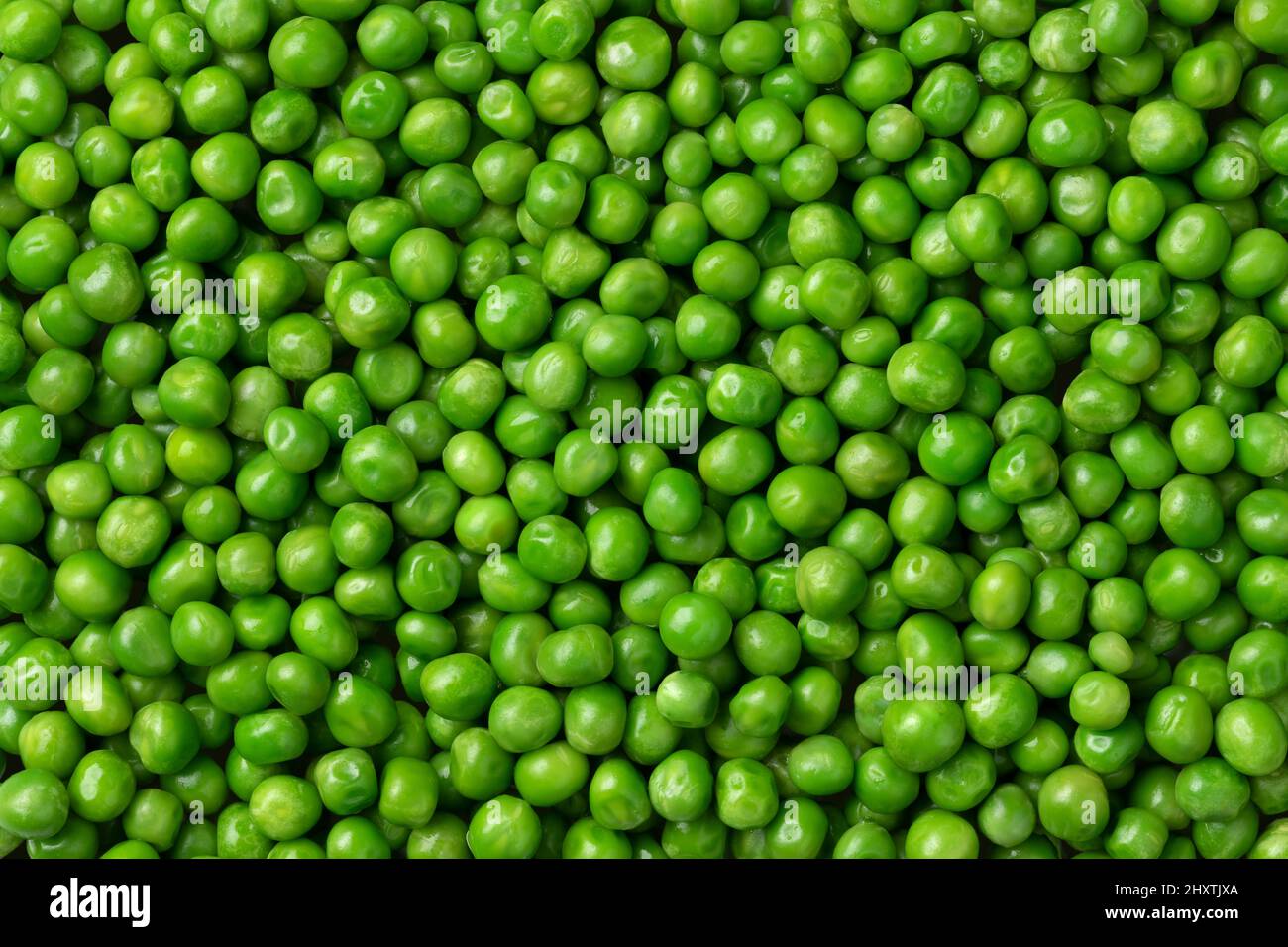 Fresh green peas close full frame as background Stock Photo - Alamy