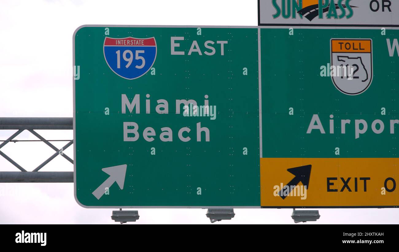 Street sign on the highway of Florida showing Miami Beach and the ...