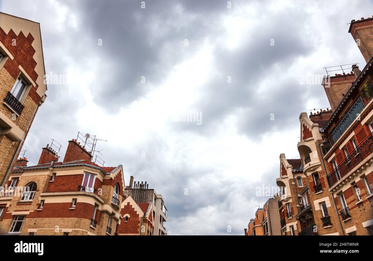 Red brick street buildings in cloudy stormy day. Paris, France Stock ...