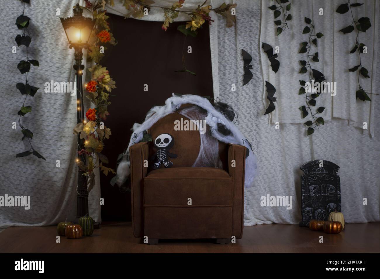 Closeup of a spooky bear sitting on an armchair in a room Stock Photo ...