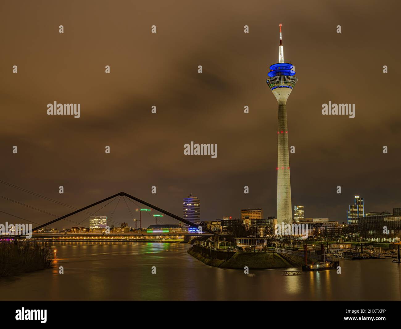 Mesmerizing view of the illuminated Rhine tower on the river with ...