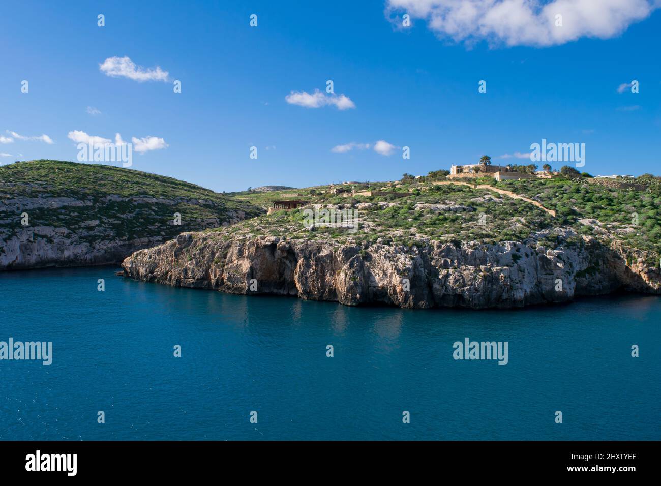 The bay and low cliffs of the drowned ria valley of Mgarr ix-Xini, in ...