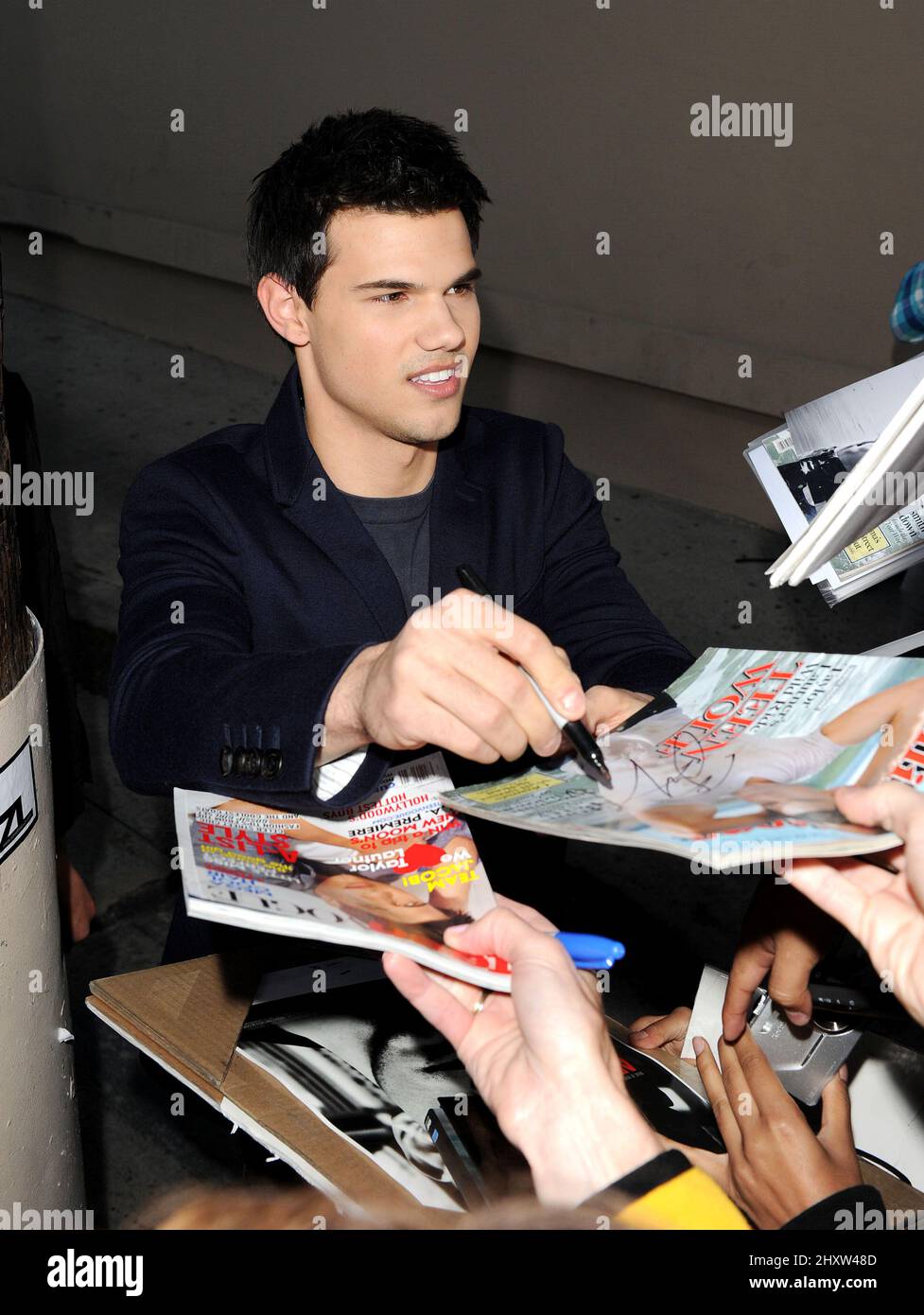 Taylor Lautner signs autographs Outside Jimmy Kimmel Live in Los ...