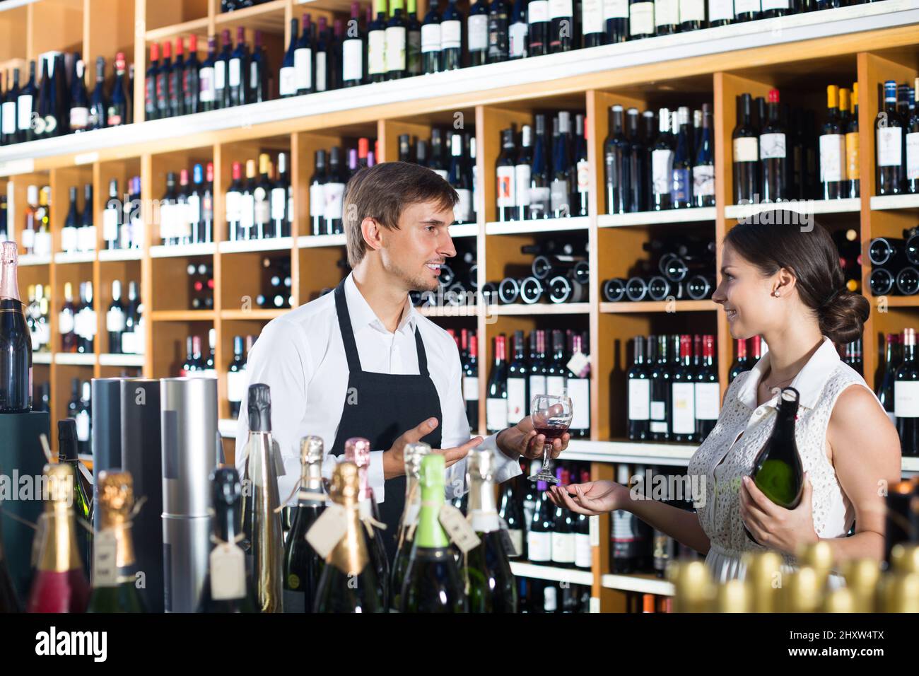 wine seller and customer in wine shop Stock Photo - Alamy