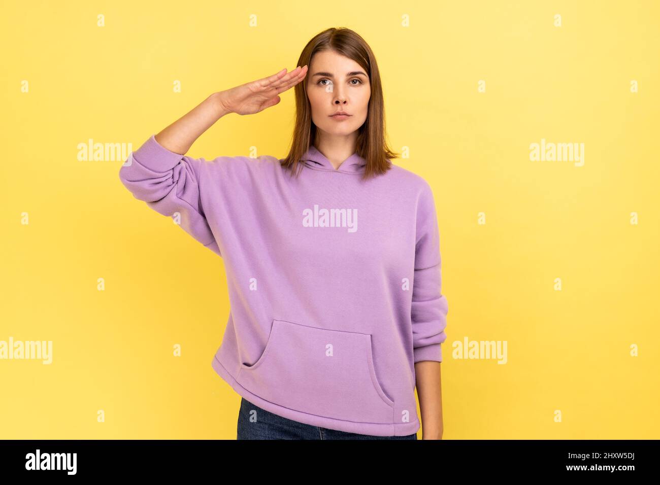 Portrait of responsible patriotic woman following discipline, saluting ...