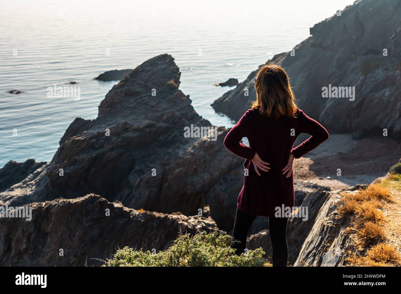 Young tourist looking at the beach in the Almanzora caves from above ...