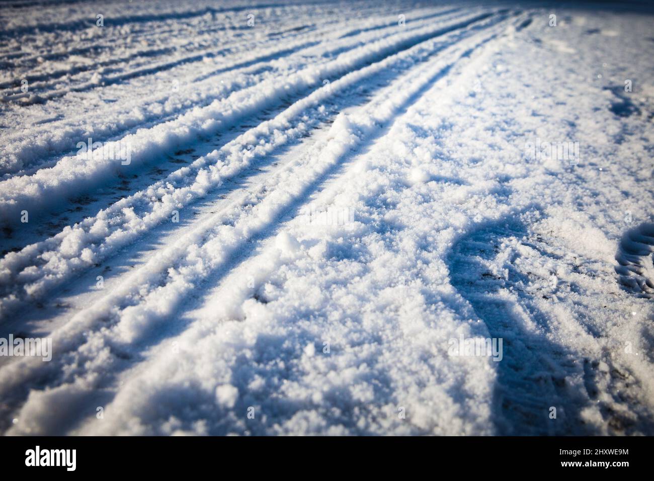 Perspective of a snow road with ice Stock Photo - Alamy