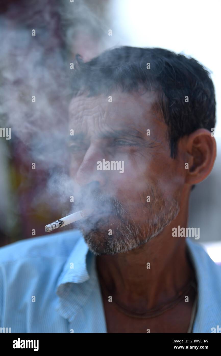 A man smoking a cigarette on ``No Smoking Day" in Agartala. No Smoking ...