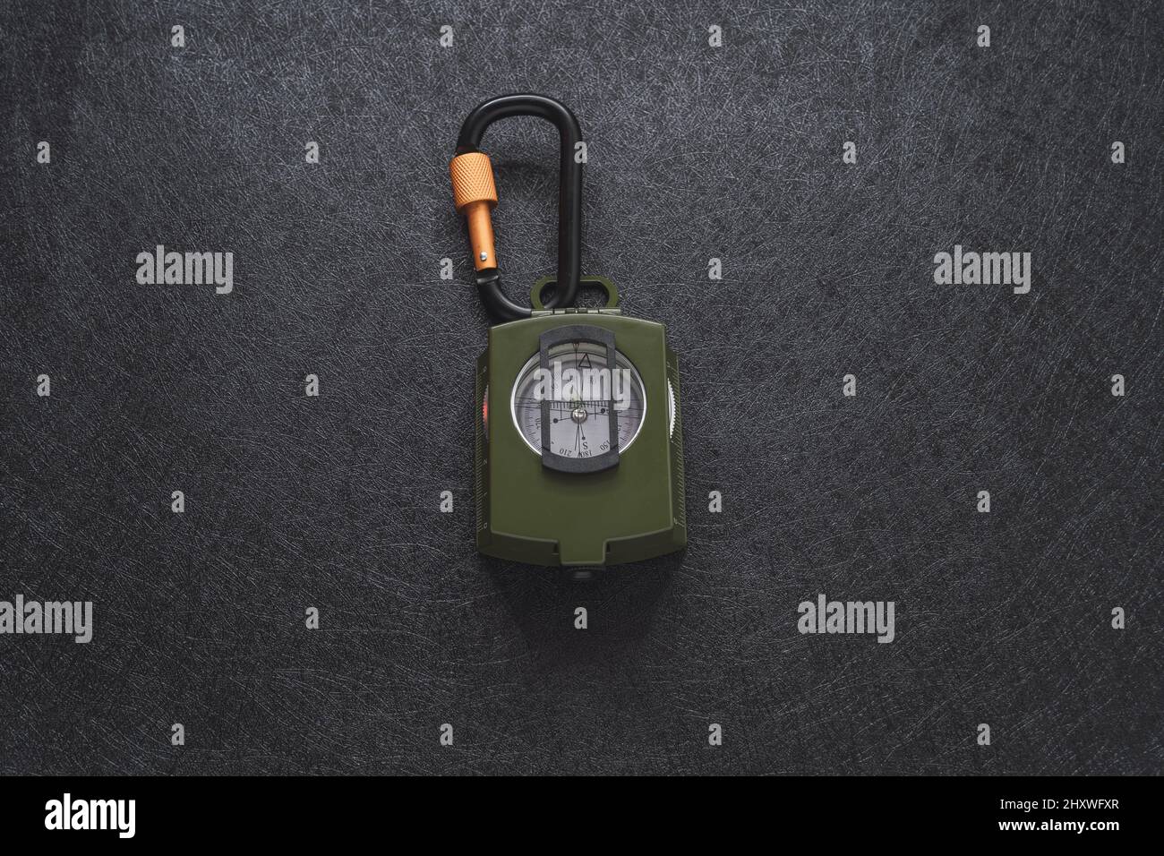 Green compass on a black textured background Stock Photo - Alamy