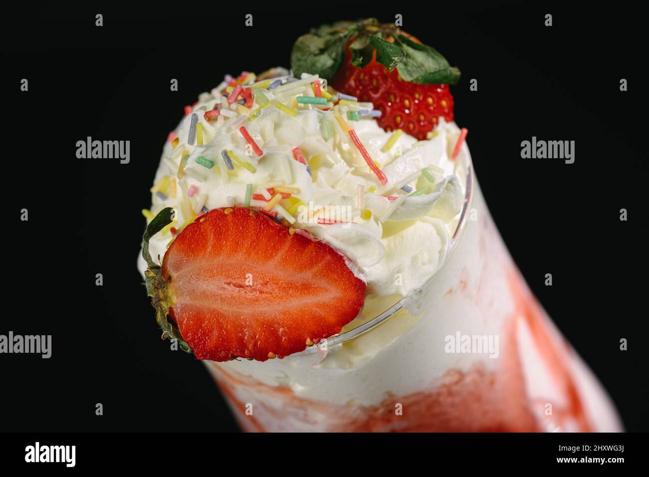 Strawberry milkshake on a black background Stock Photo - Alamy