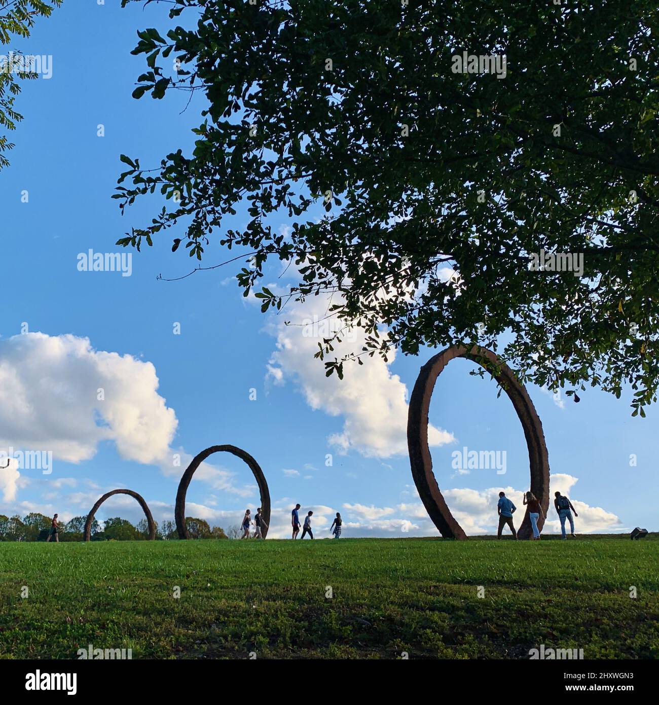 Visitors at the North Carolina Museum of Art on a blue cloudy sky ...
