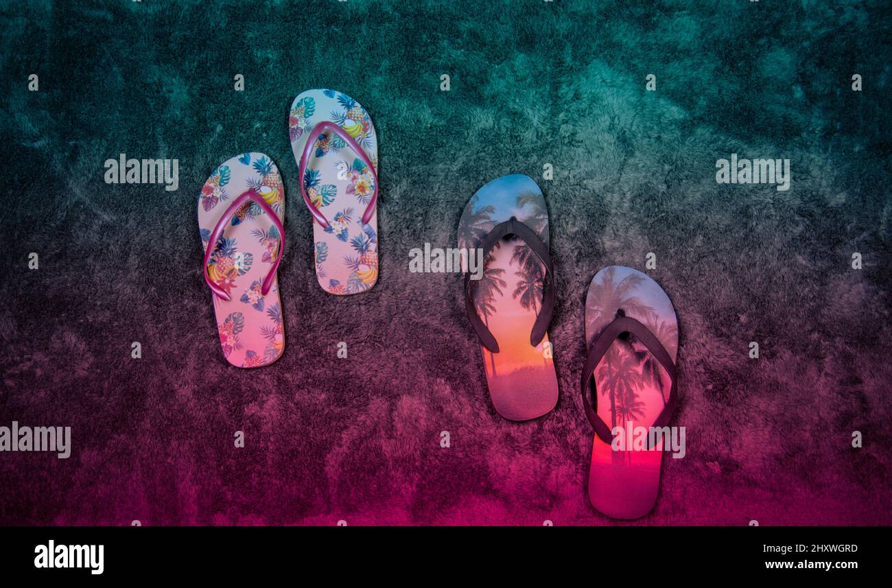 Top view of colorful flip flops on a sandy background Stock Photo - Alamy