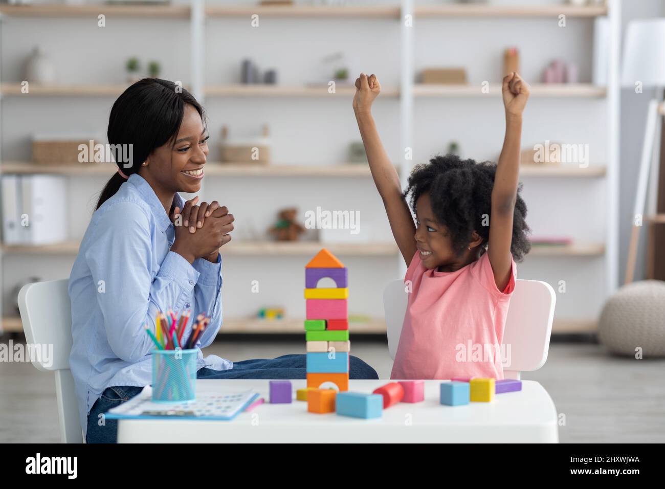 Smart little black girl having session with child development ...