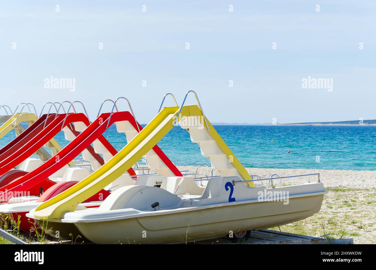 Boats with slides on a beach Stock Photo - Alamy