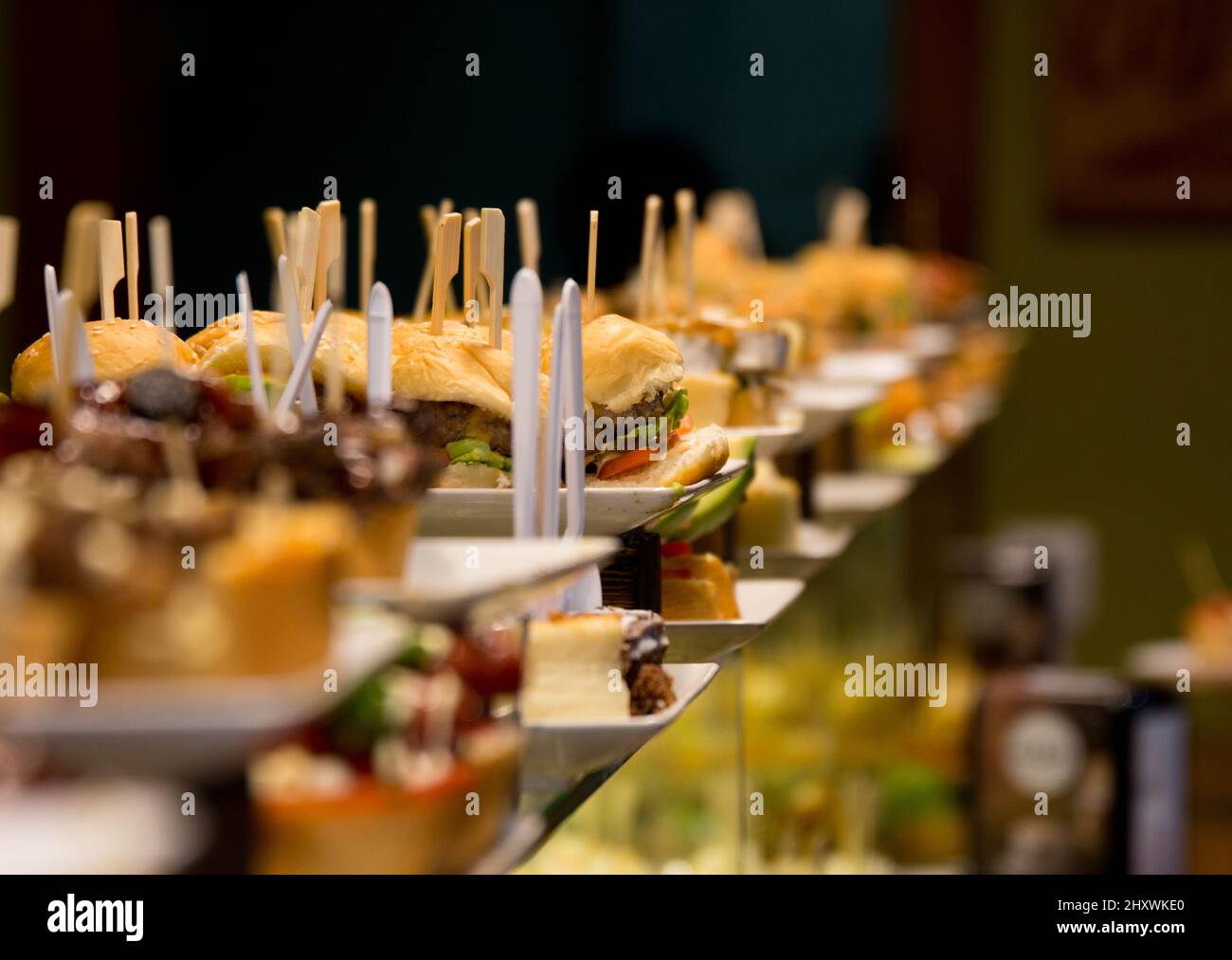 Closeup of the pinchos with wooden sticks on top. Catering products on ...