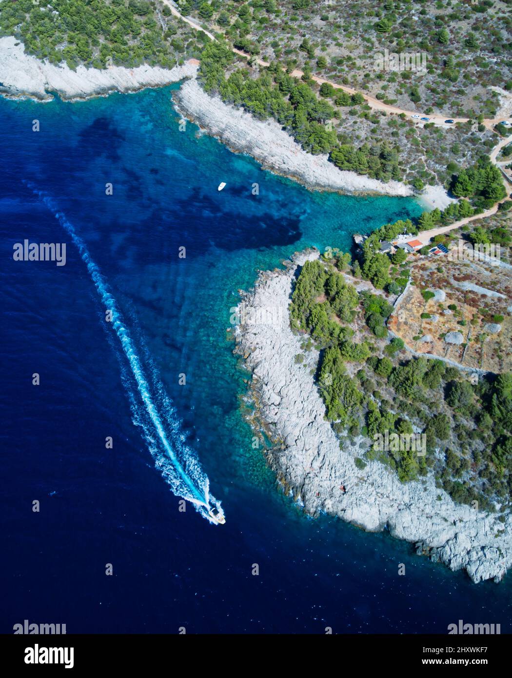Aerial view of a coastal landscape with a boat in the sea Stock Photo ...