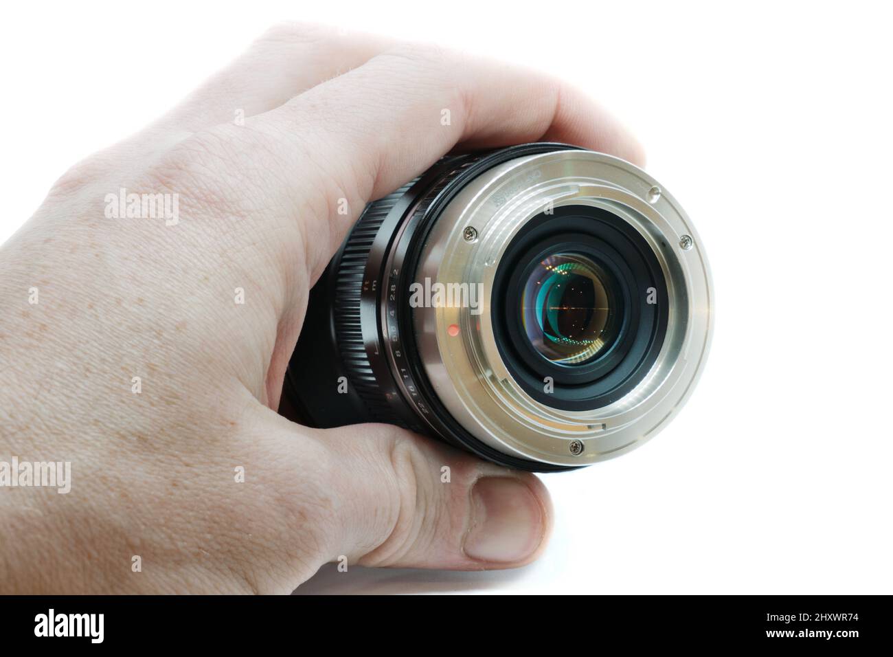 photography lens in hand close up, bayonet mount isolated on white ...