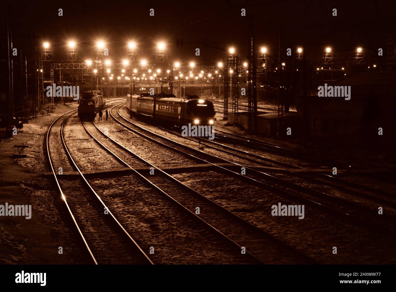 railway station with trains at night in sepia tone Stock Photo - Alamy