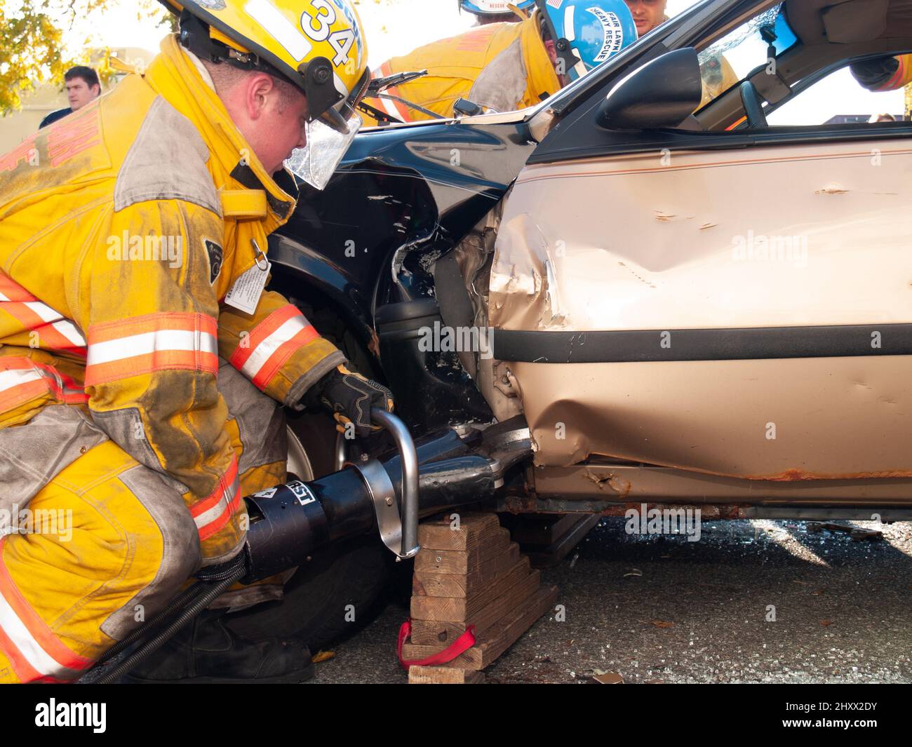 Rescue worker with wrecked car during drill Stock Photo - Alamy
