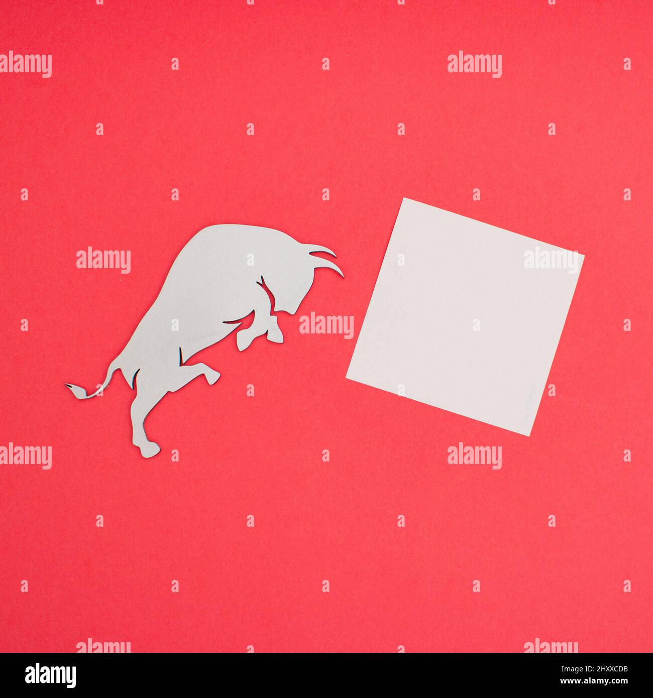 Top view of a bull stencil and a square sheet of paper with copy space ...
