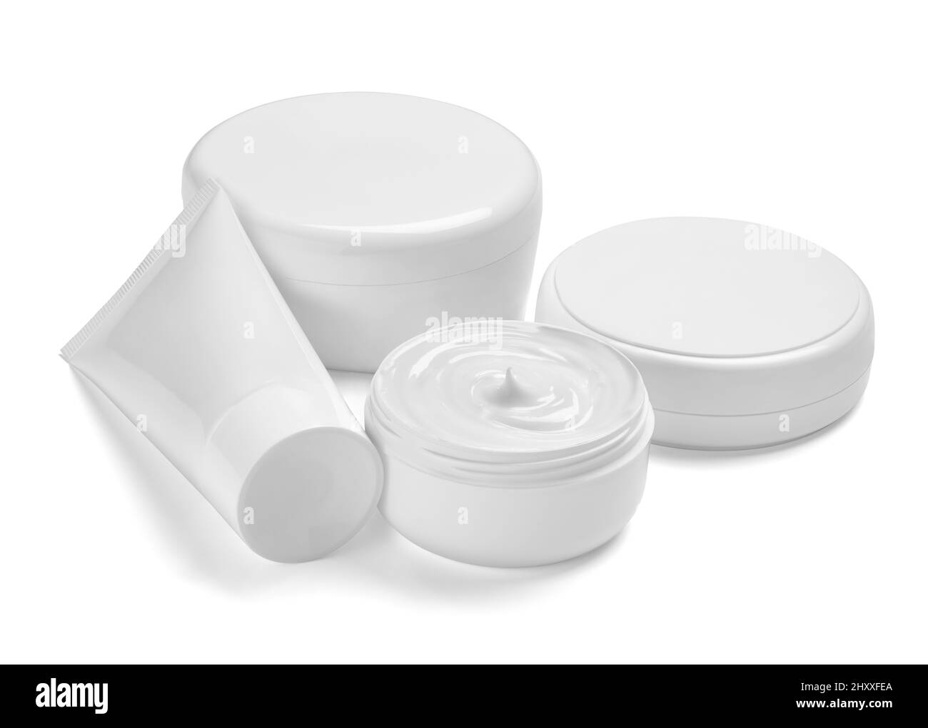 close up of a white beauty cream container and tube on white background ...