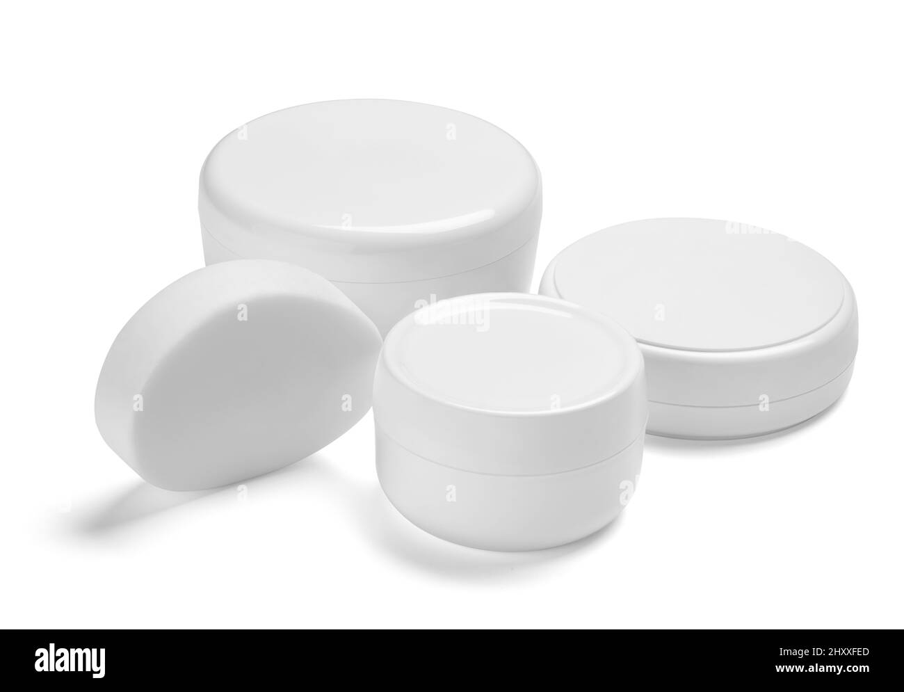 close up of a white beauty cream container and tube on white background ...