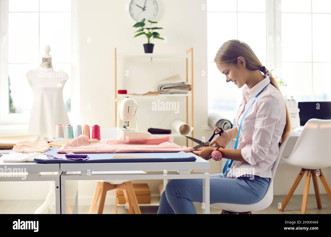 Smiling female seamstress design garment in atelier Stock Photo - Alamy