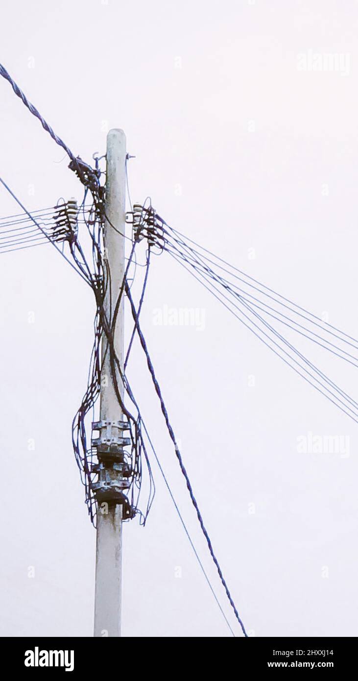 Vertical shot of electricity wires under a bright sky Stock Photo - Alamy