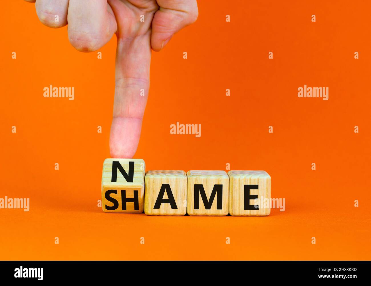 Name or shame symbol. Businessman turns the wooden cube and changes the ...