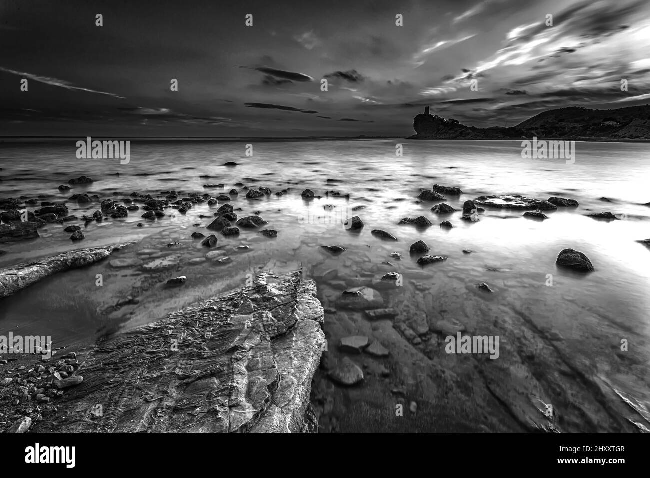 Grayscale Beautiful shot of a coastal sunset in a blue sky Stock Photo ...