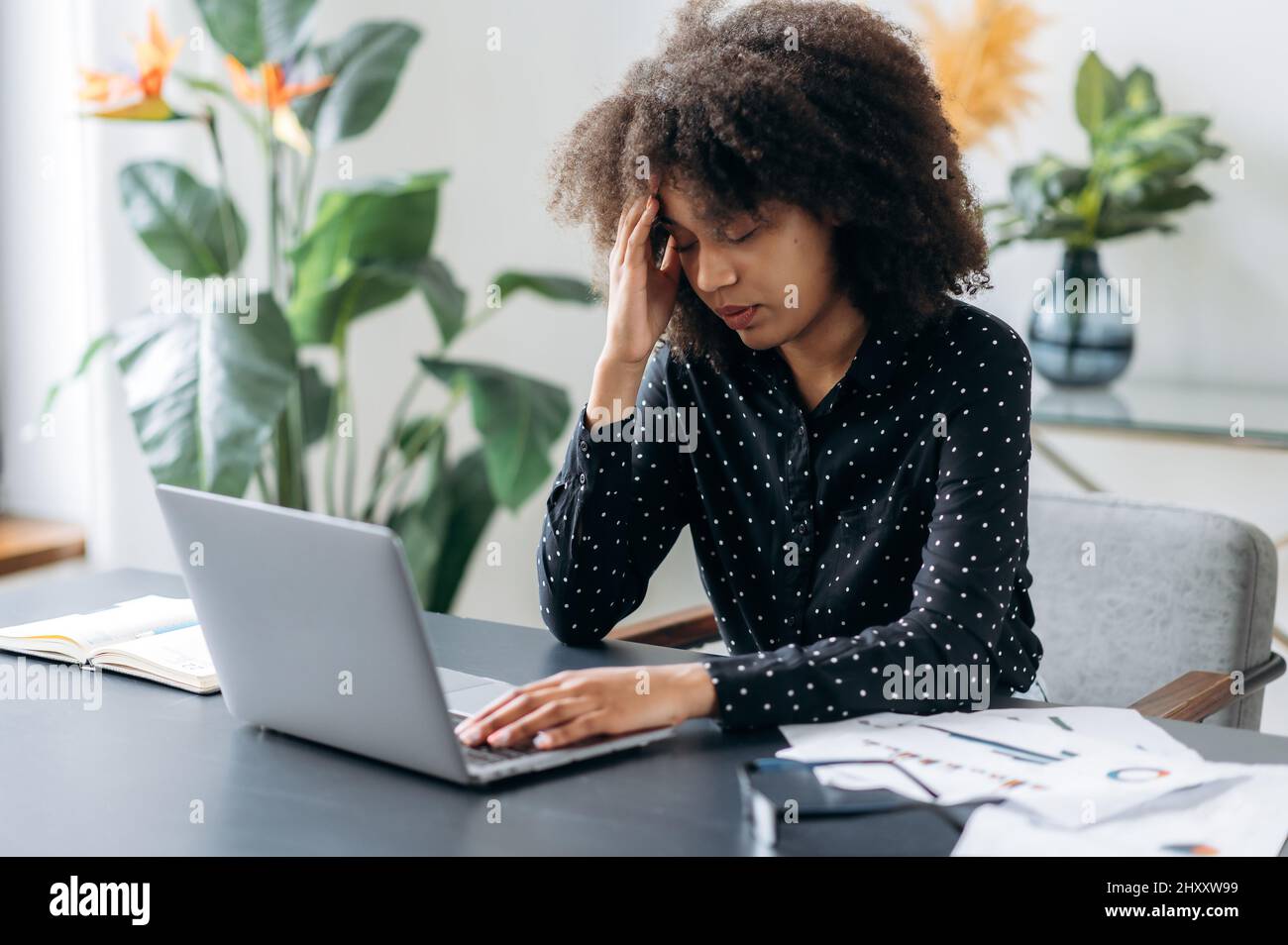 Tired from laptop work sad african american young woman, freelancer or ...