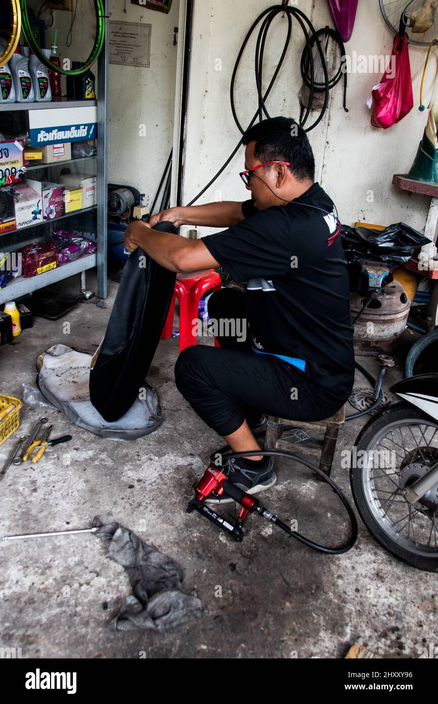 Vertical shot of a motorcycle mechanic working in his shop Stock Photo ...