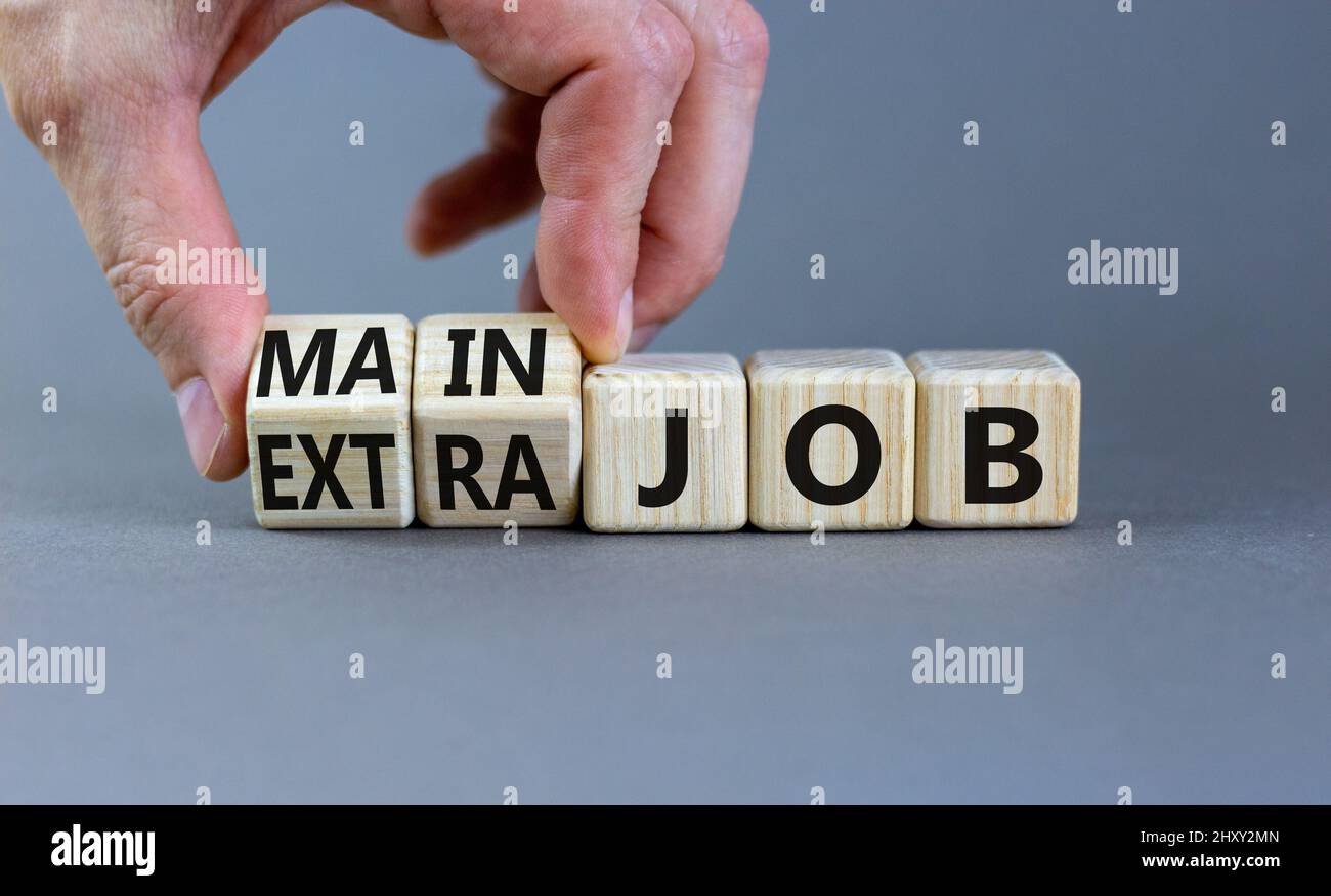 Extra or main job symbol. Businessman turns wooden cubes and changes ...