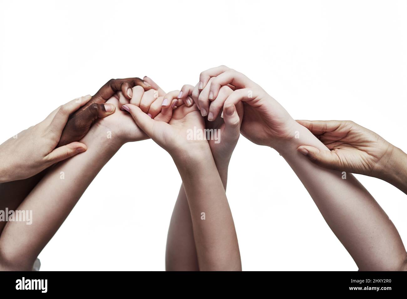 Embracing unity through diversity. Shot of a group of hands holding on ...