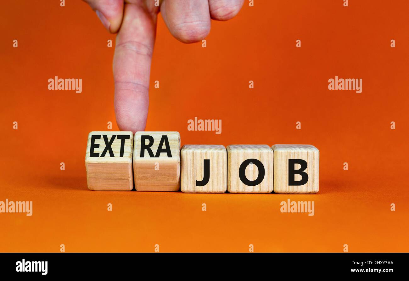 Extra job symbol. Businessman turns wooden cubes and changes concept ...