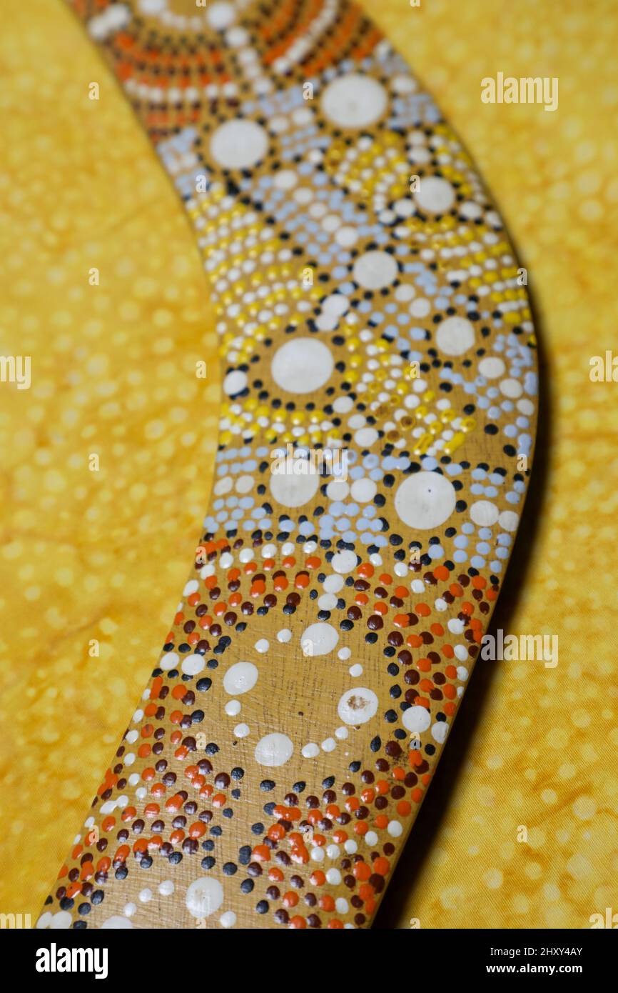 Vertical close-up shot of a wooden boomerang with dot drawings Stock ...