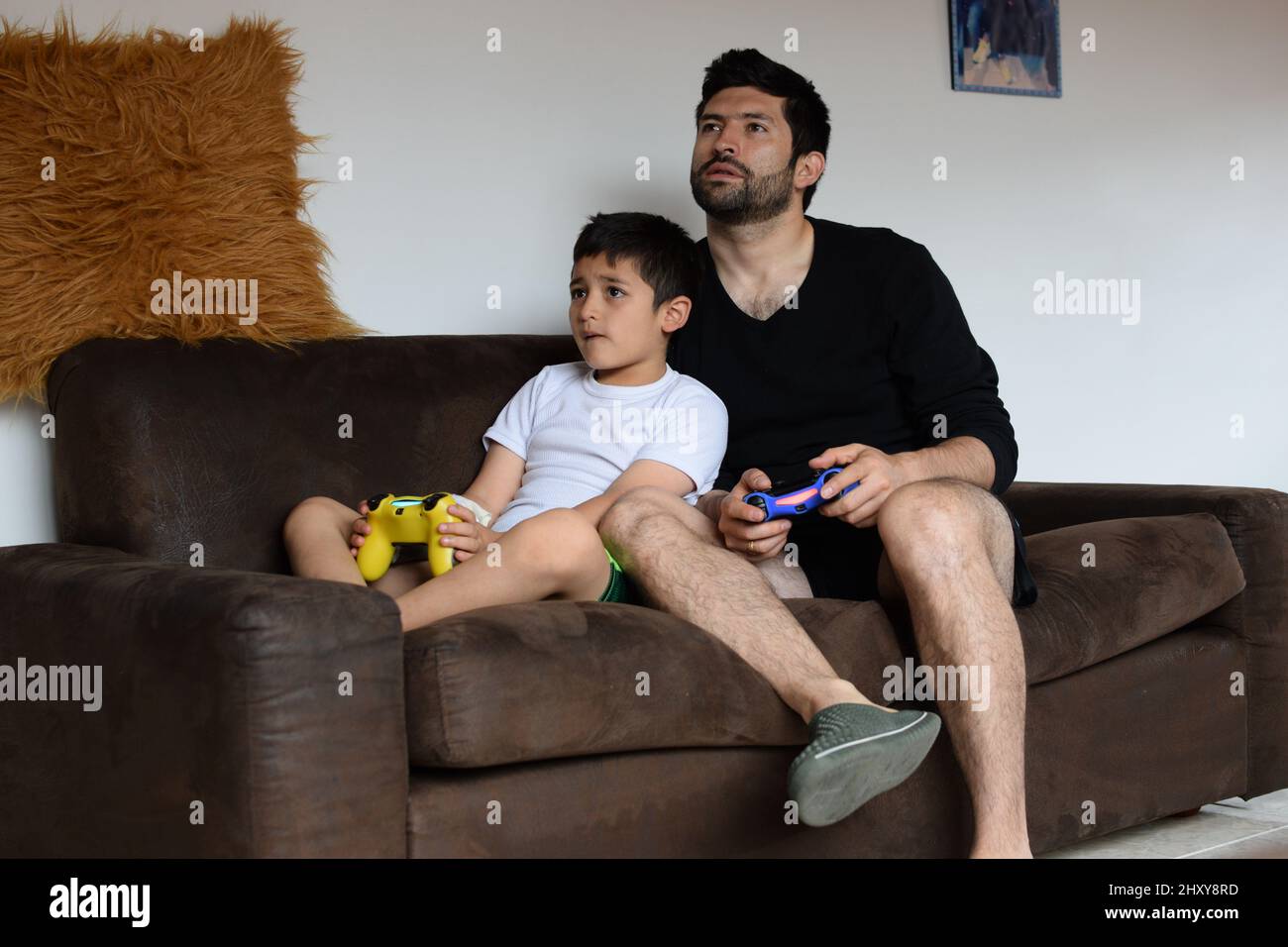Photo of dad and son playing video games Stock Photo - Alamy