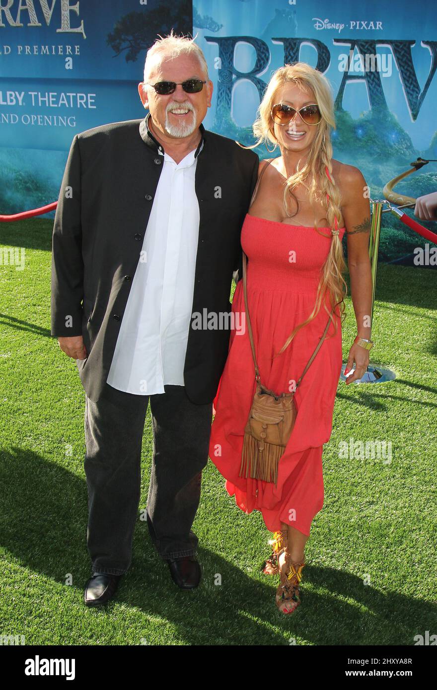 John Ratzenberger and Julie Rabado attending the "Brave" premiere ...