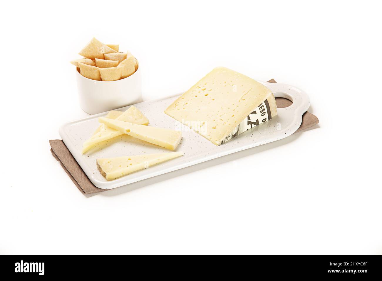 White plate with a piece of cheese and slices on the side isolated on ...
