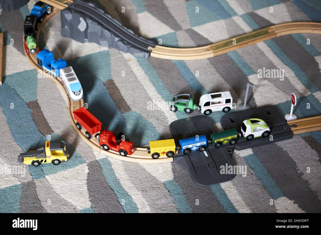A collection of plastic toy trains and locomotives with wooden tracks ...