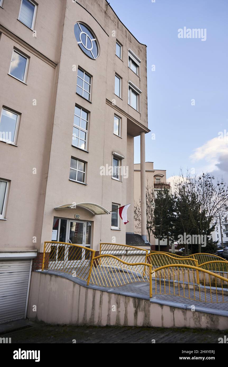 Front entrance of an apartment building with a Polish flag in the Stare ...