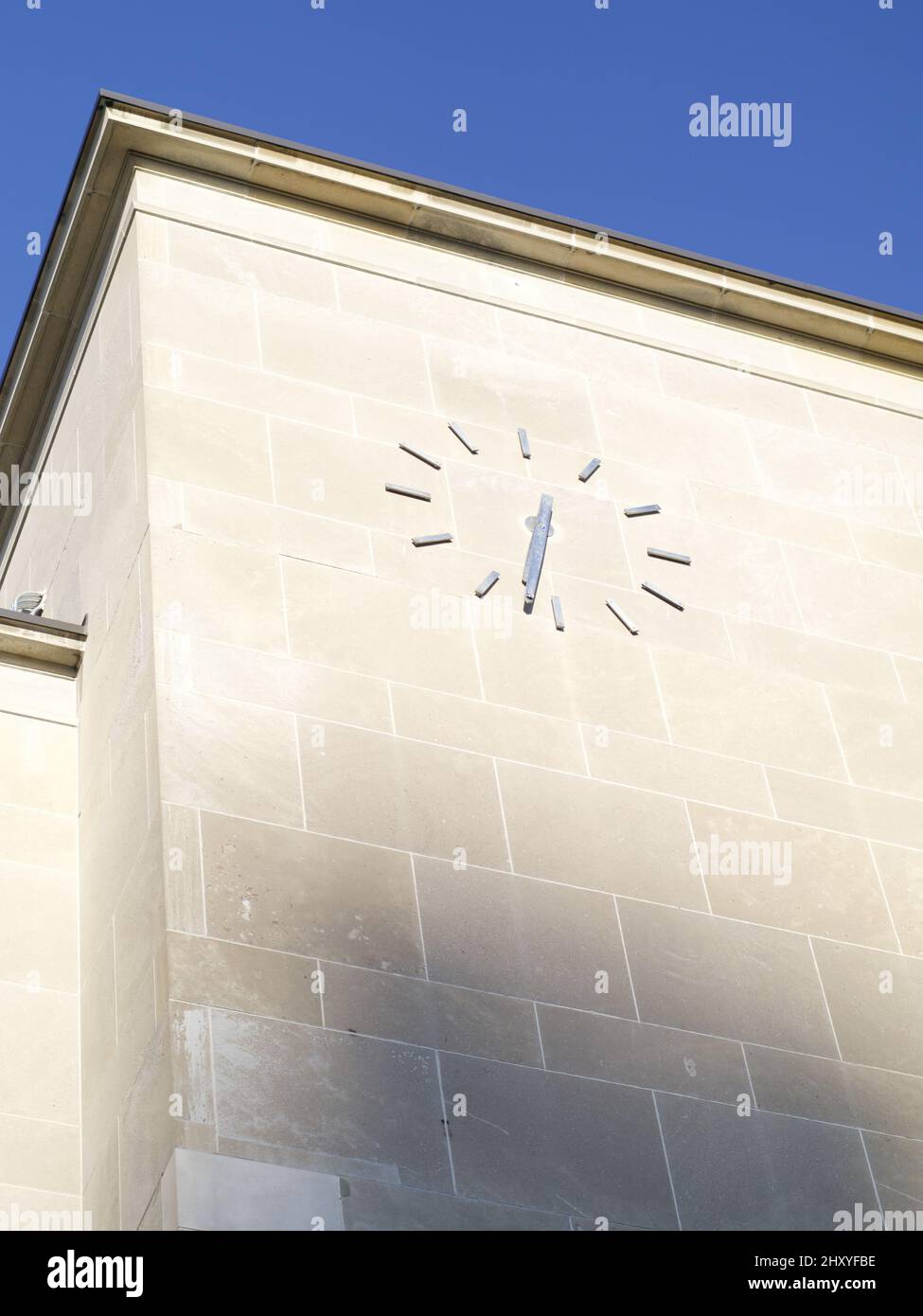 Low angle of a modern facade clock Stock Photo - Alamy