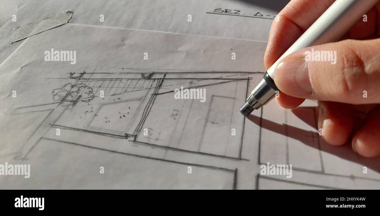 Of a hand that draws on paper with a pencil Stock Photo - Alamy