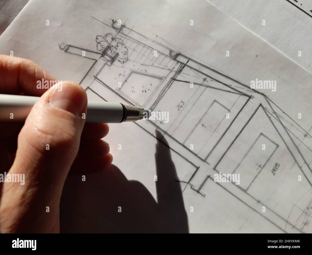 Of a hand that draws on paper with a pencil Stock Photo - Alamy