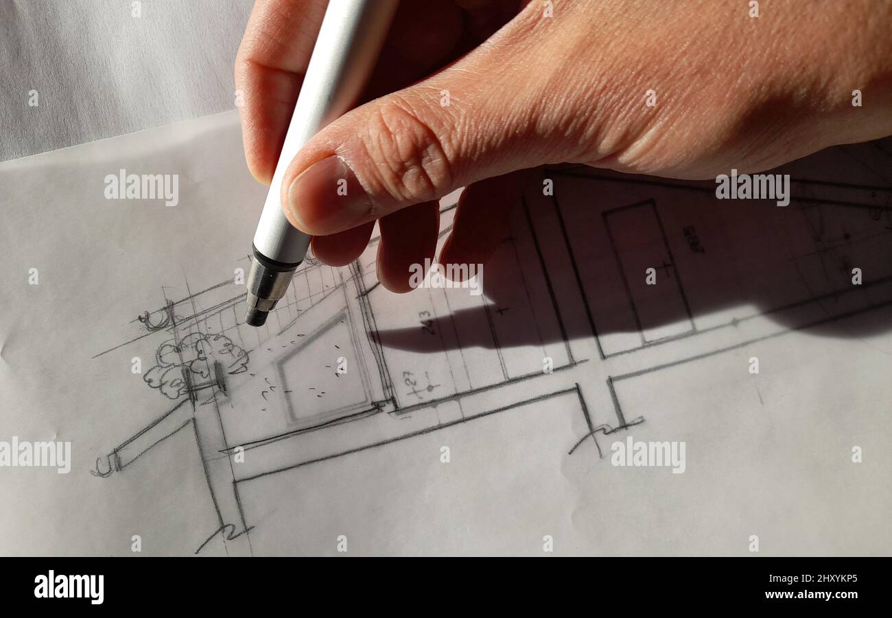 Of a hand that draws on paper with a pencil Stock Photo - Alamy