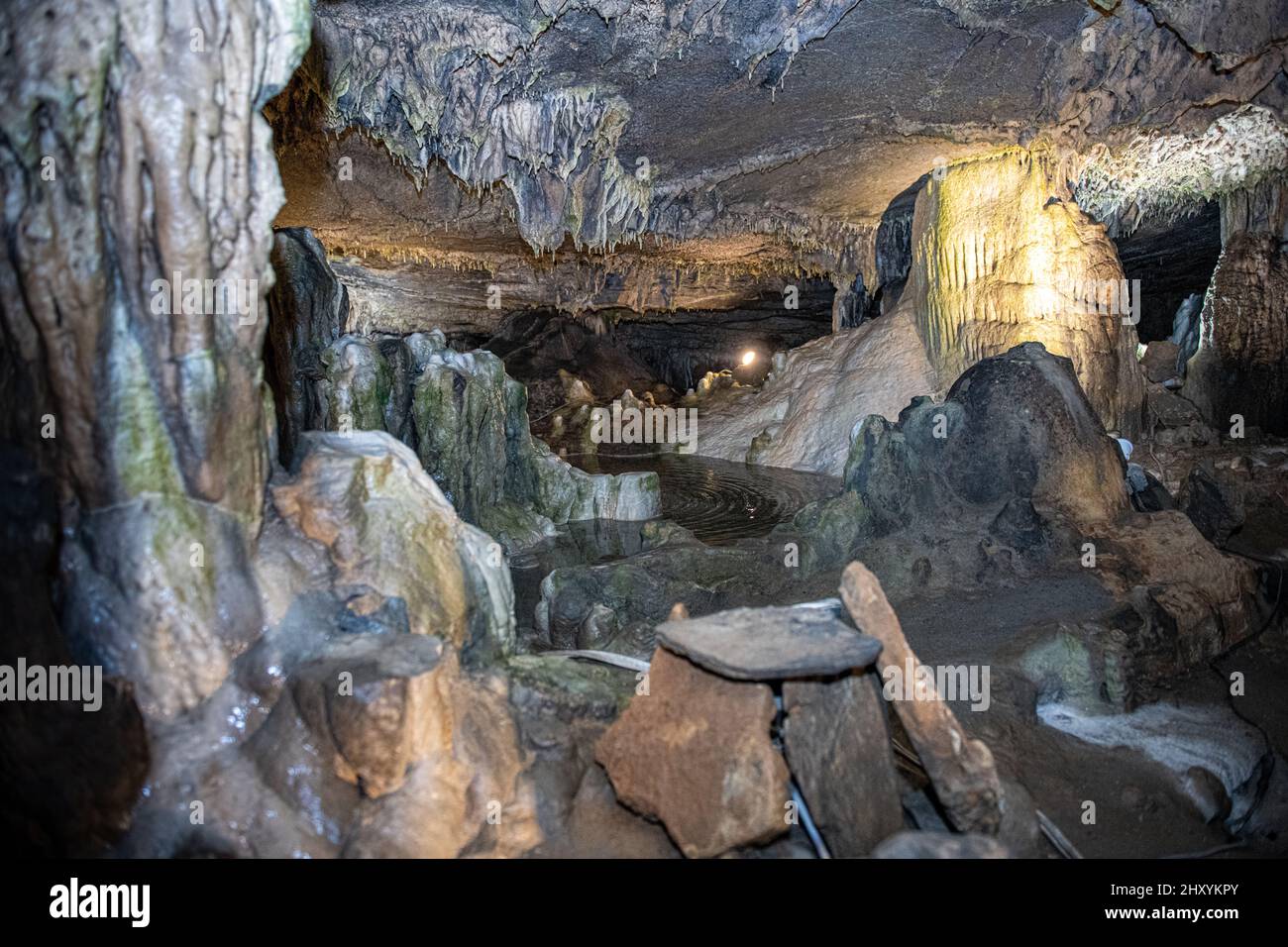 Large cave with many rock formations and water puddle Stock Photo - Alamy